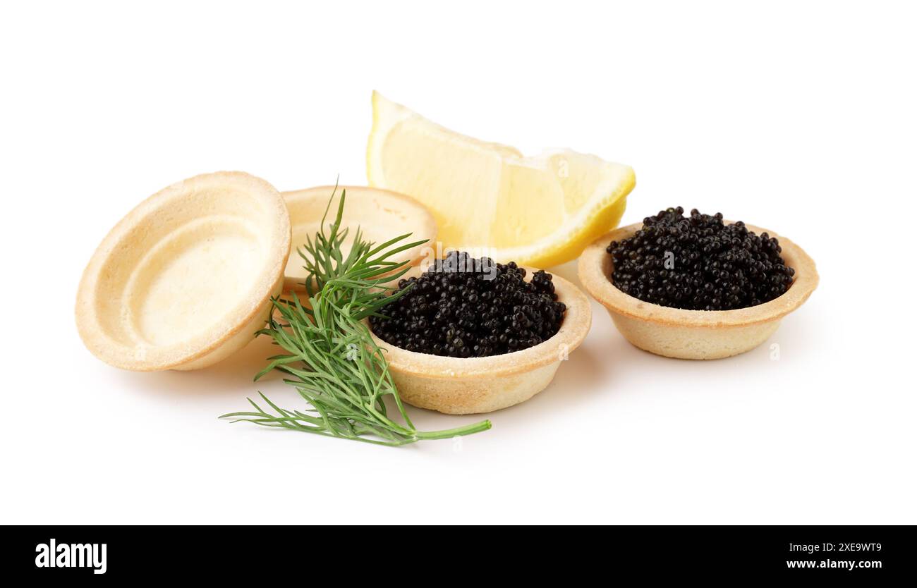 Tasty tartlets with black caviar and lemon on white background Stock ...