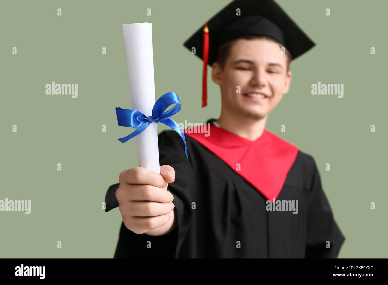 Happy male graduate with diploma on green background Stock Photo - Alamy