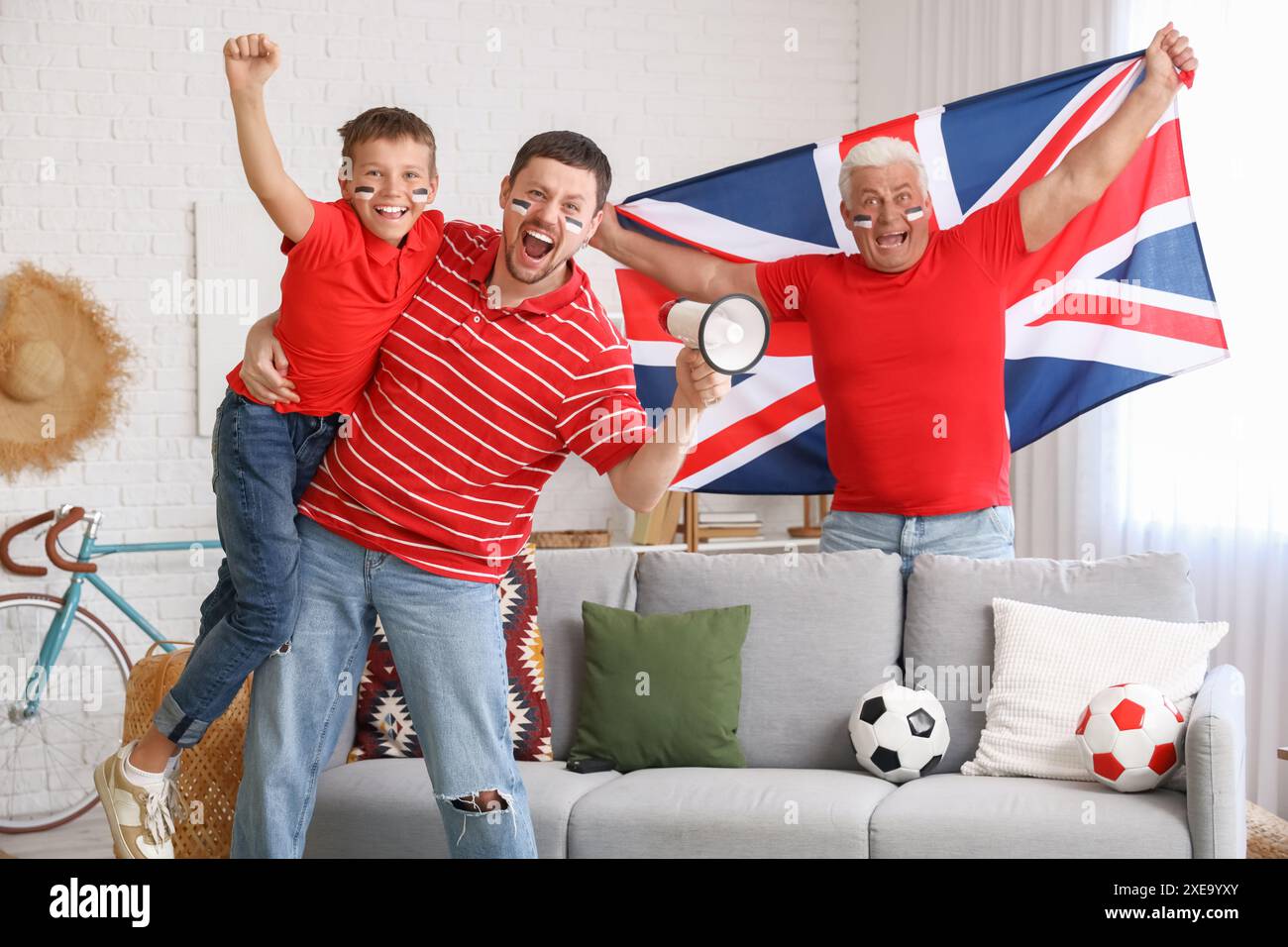 Man with his father and son cheering for football team with megaphone ...