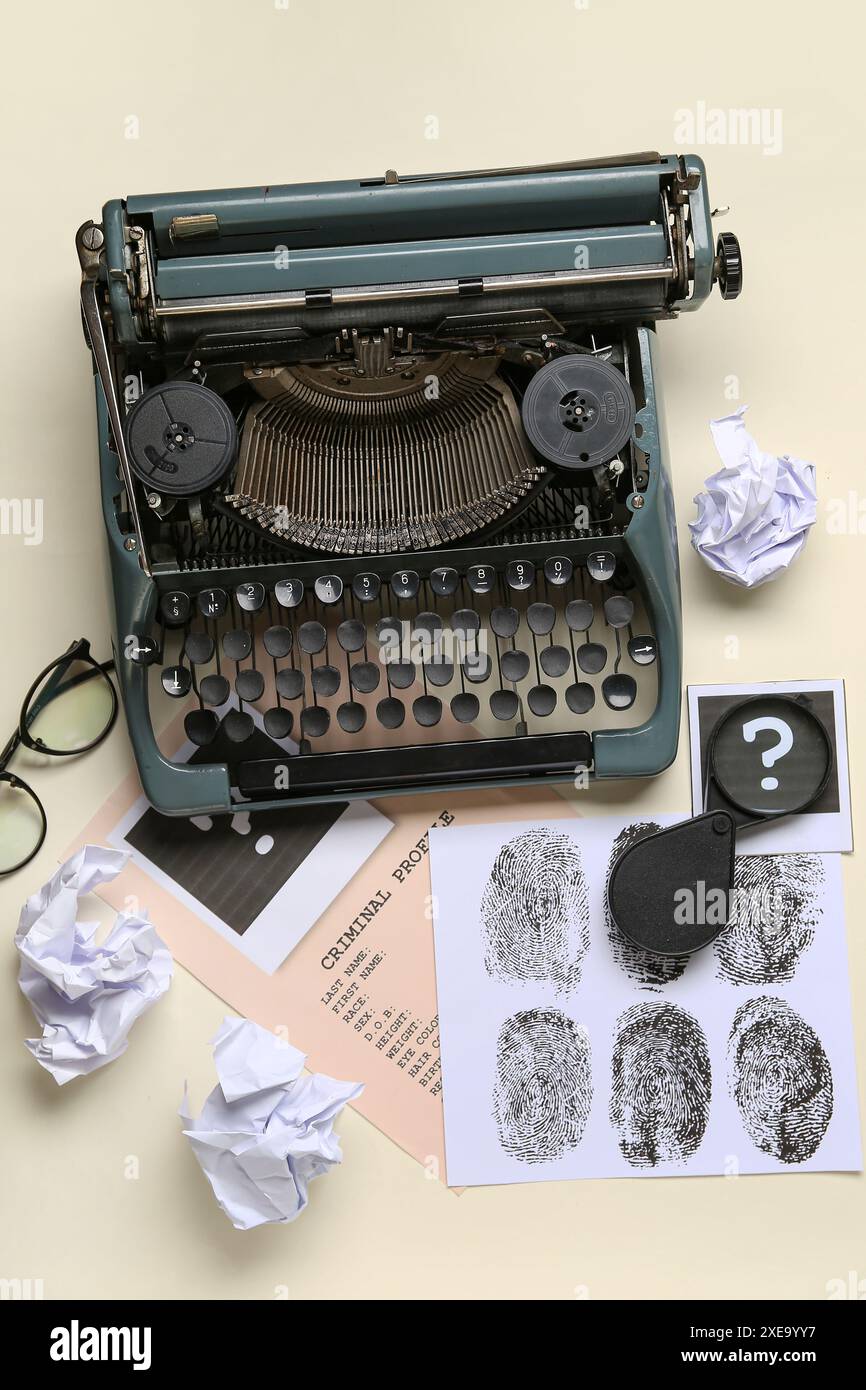 Composition with retro typewriter, criminal files and crumpled paper ...