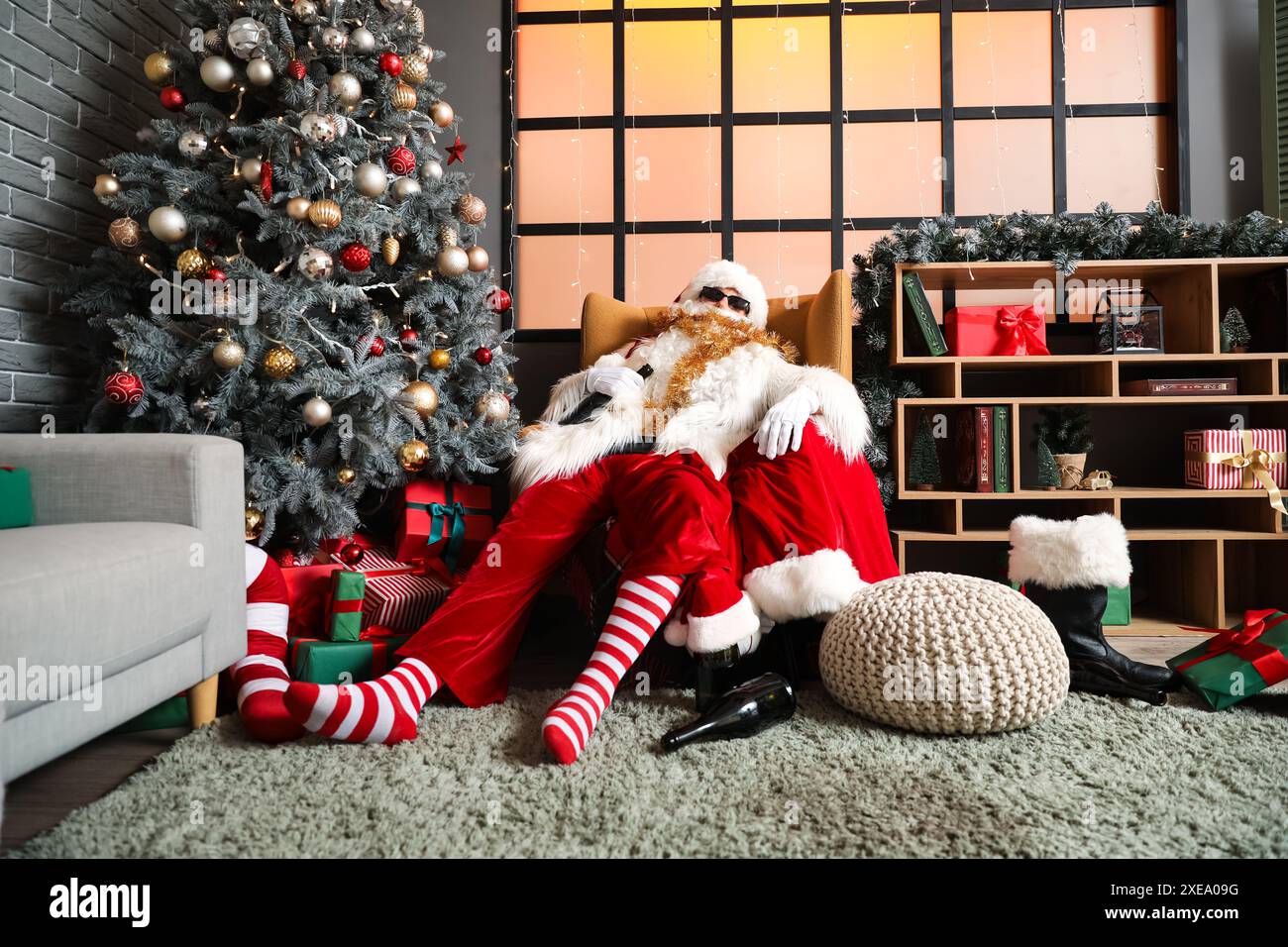 Drunk Santa Claus with bottle sleeping in armchair after party Stock ...