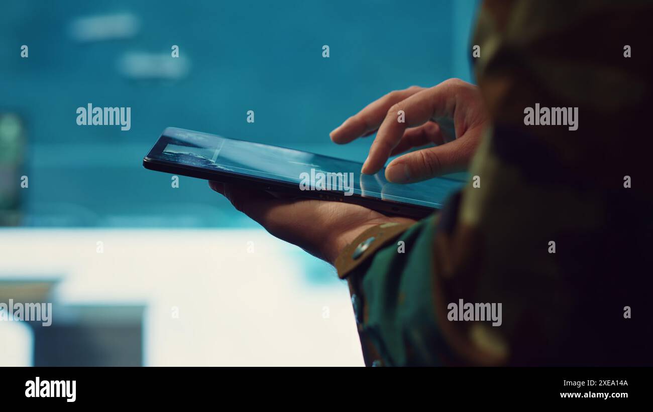 Army officer examines reconnaissance system on a world map, targeting ...
