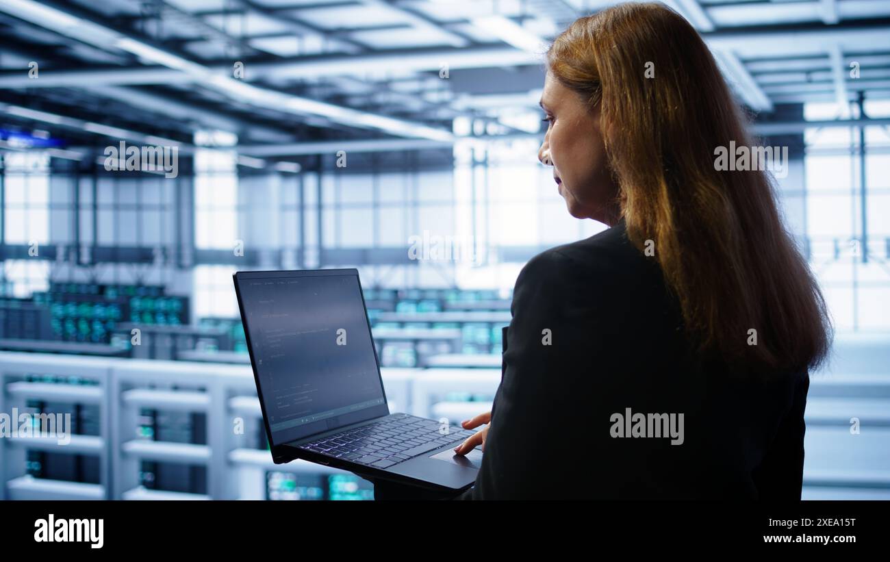 System Administrator In Data Center Typing On Laptop Running Error Checking Utilities To Fix 9810