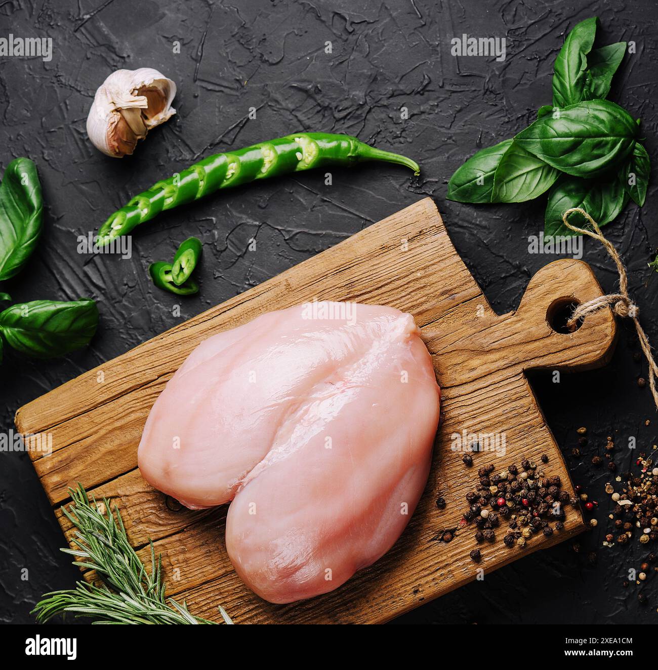 Raw chicken fillets on wooden cutting board, top view Stock Photo - Alamy