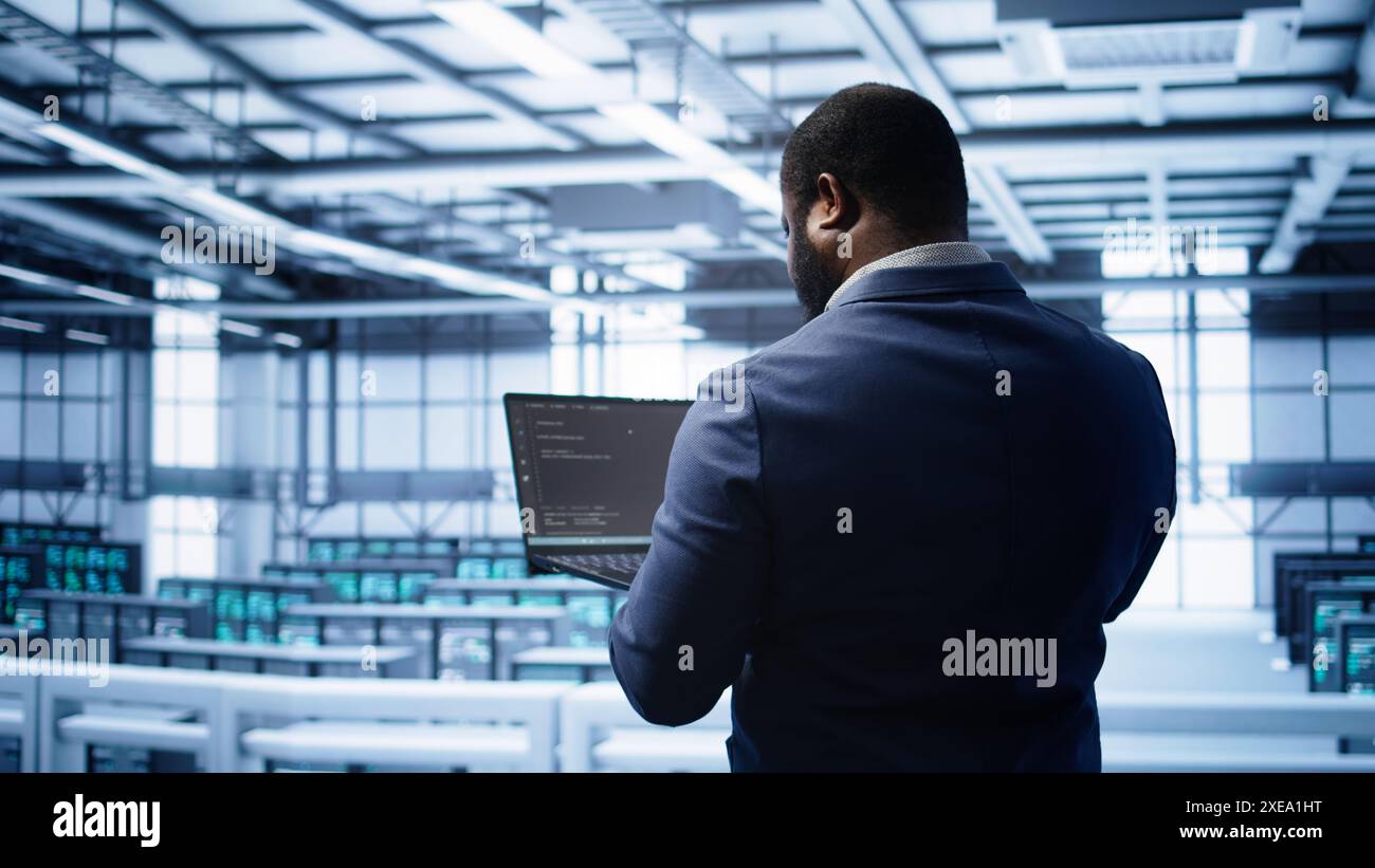 African american admin in data center running error checking utilities on tablet to fix hardware ...