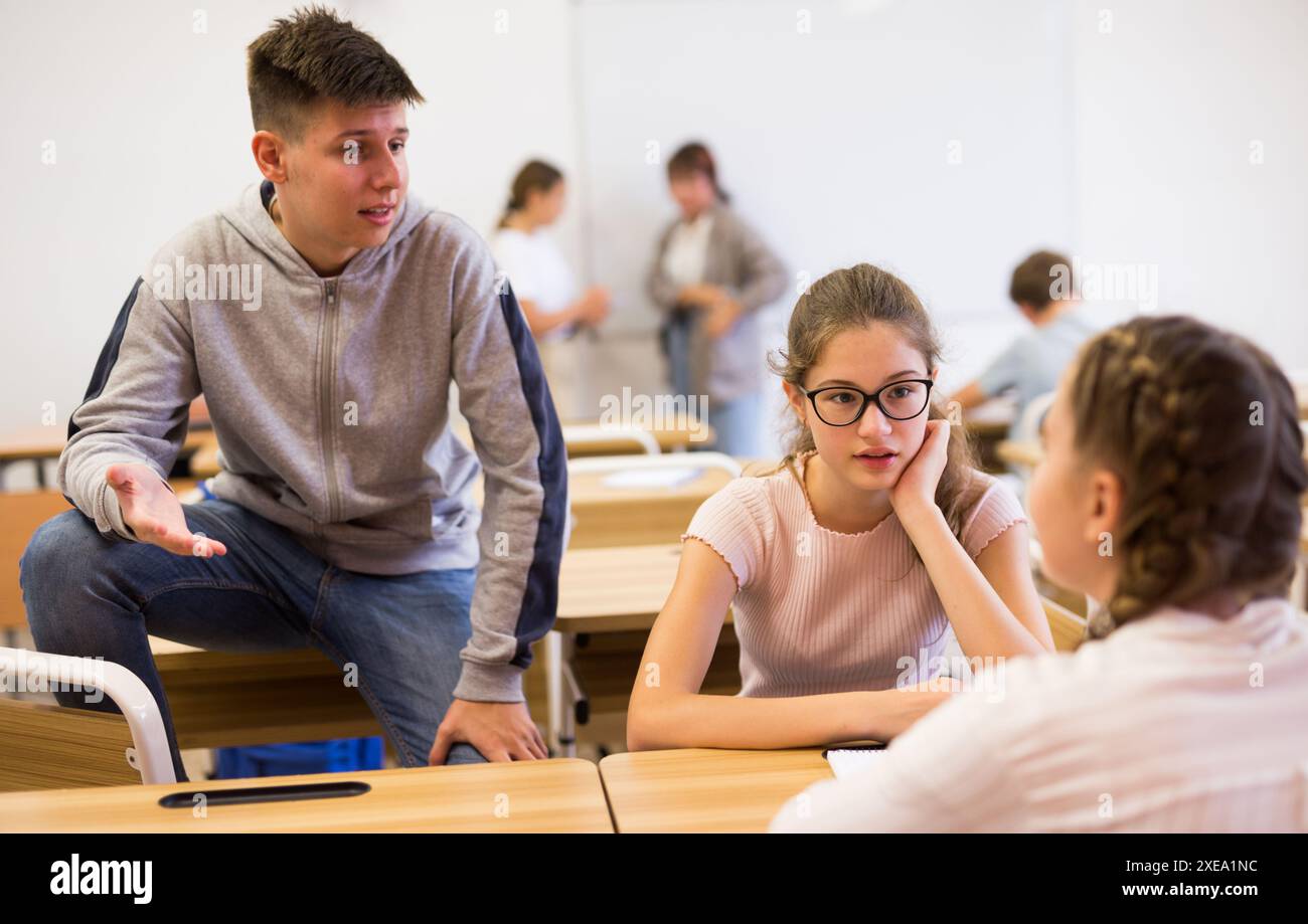 Teenage students talking during recess between lessons Stock Photo - Alamy