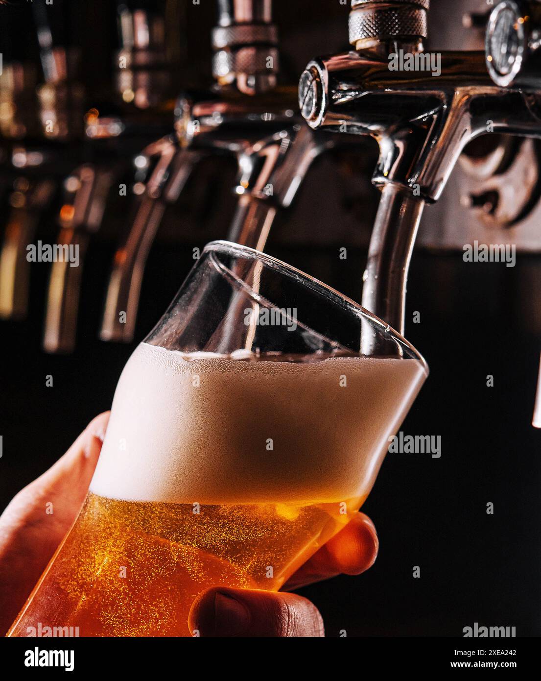 Barman pouring beer into glass hi-res stock photography and images - Alamy