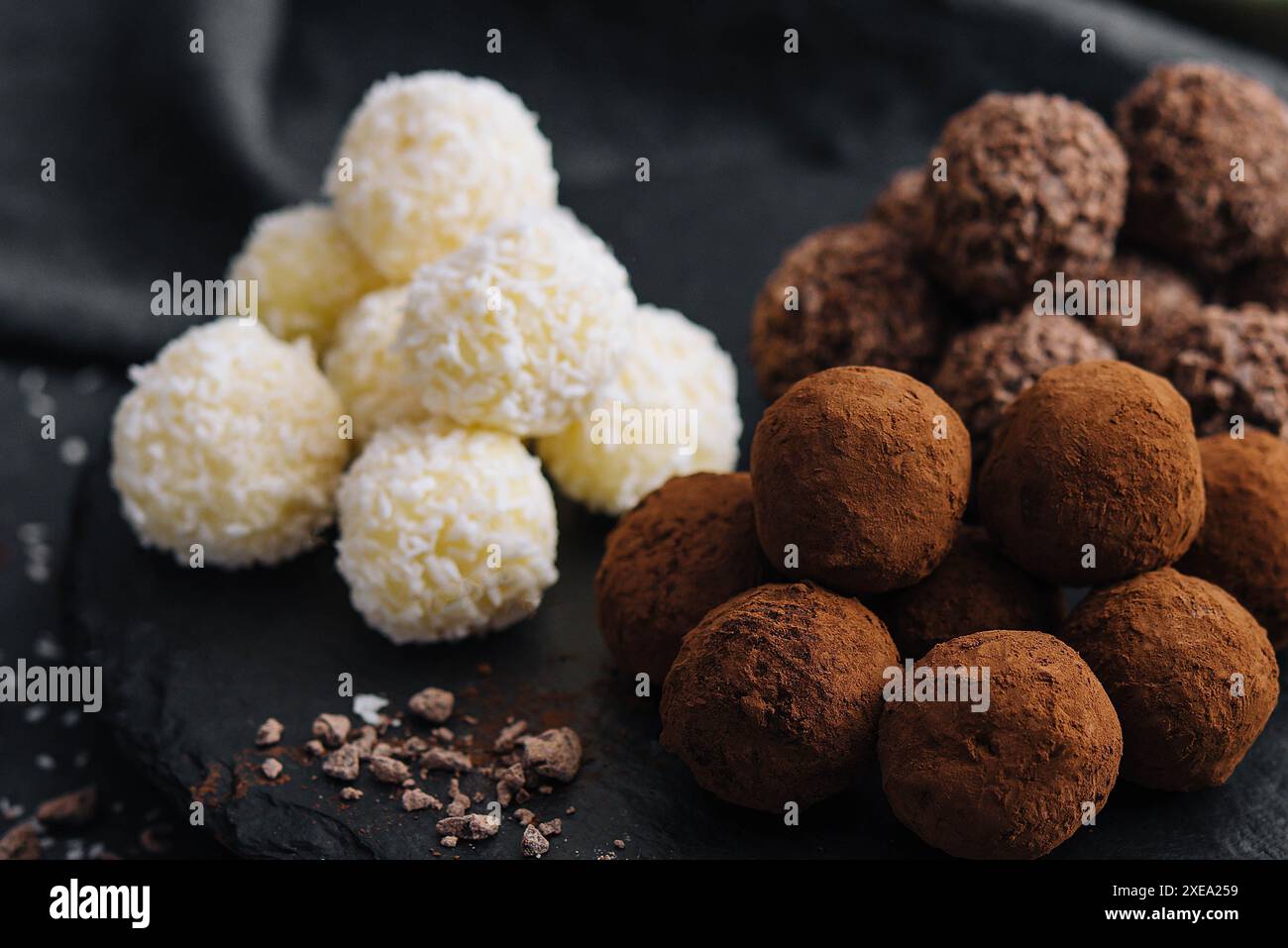 Three types of chocolate balls on stone board Stock Photo - Alamy