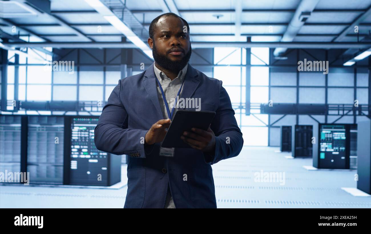 Software developer managing data center with advanced technology, ensuring efficient network ...