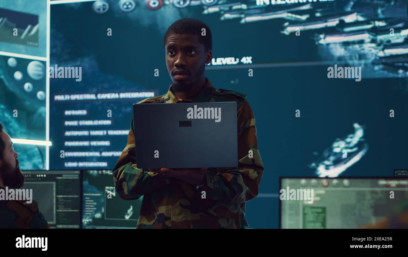 Infantry unit leader examines big data on a screen in military ...