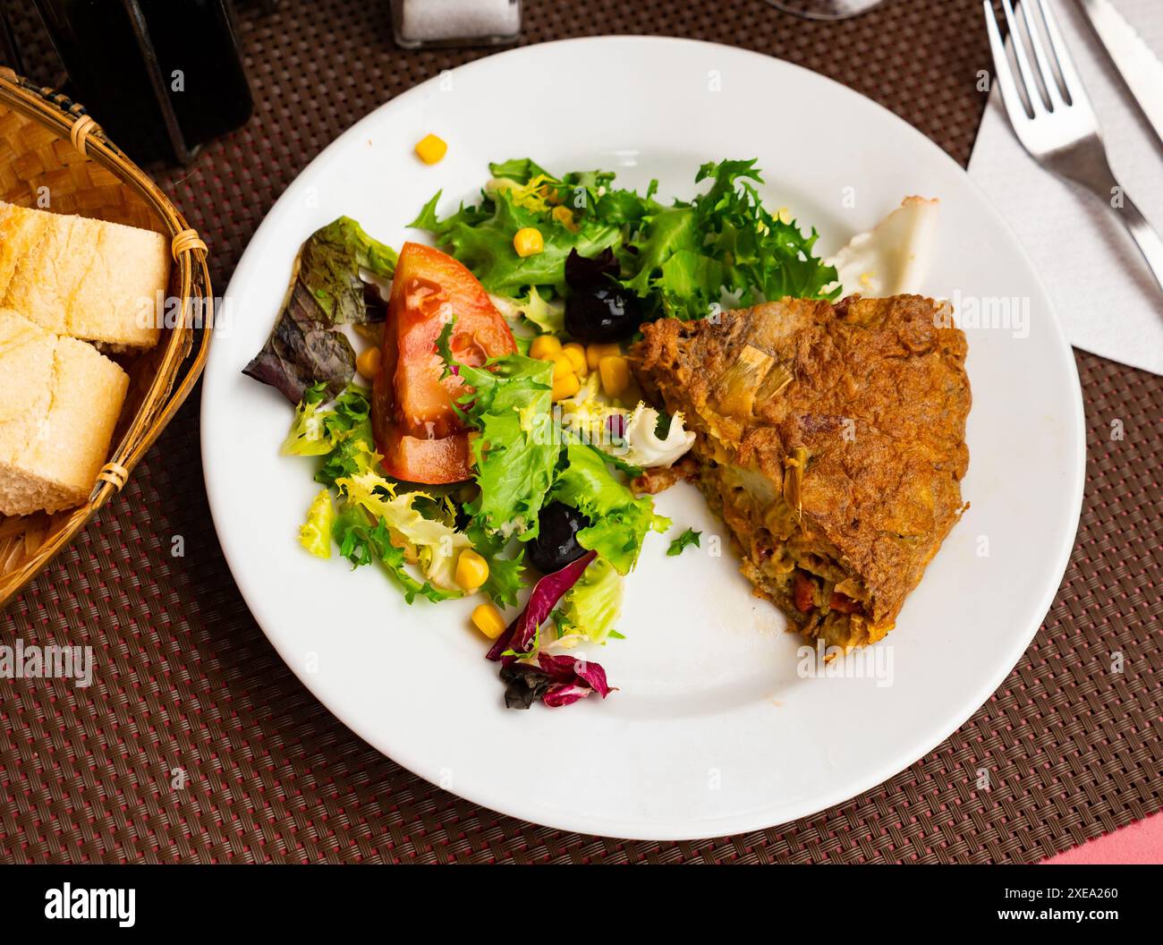 Traditional Spanish artichoke tortilla with fresh salad Stock Photo - Alamy