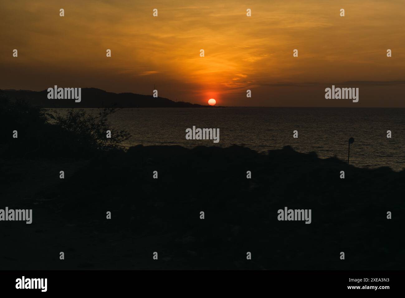 sunset with red sky with clouds on the beach in Latin America Stock ...