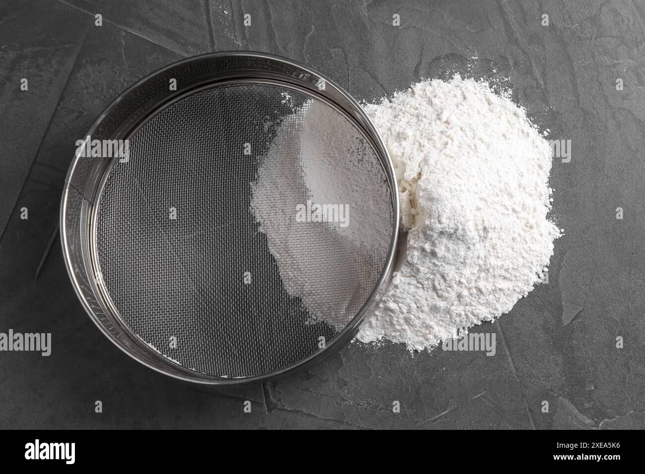 Metal sieve and flour on grey table, top view Stock Photo - Alamy