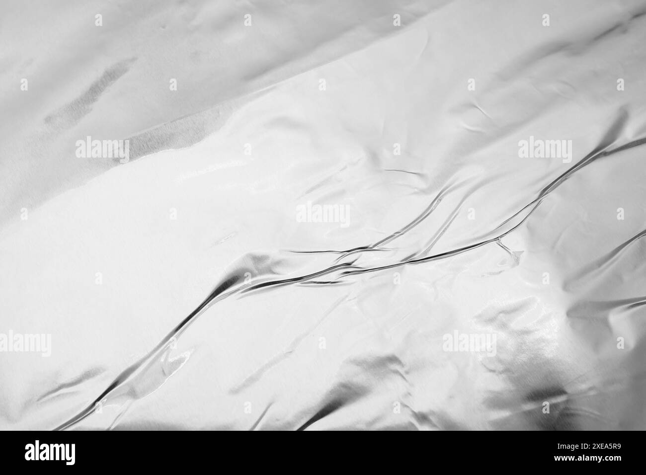 Crumpled silver foil as background, above view Stock Photo - Alamy