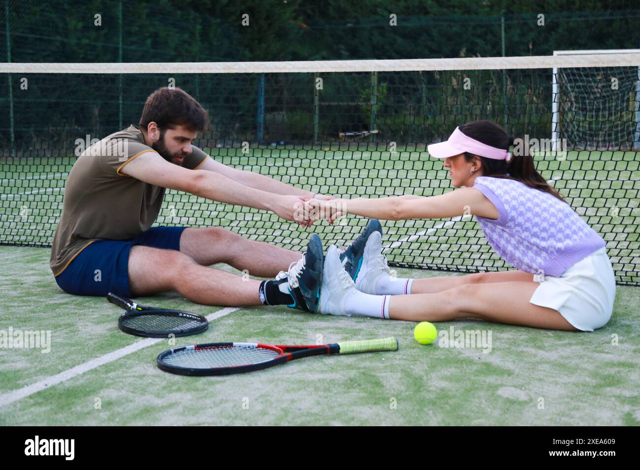 Tennis Players Stretching Hand In Hand Stock Photo - Alamy