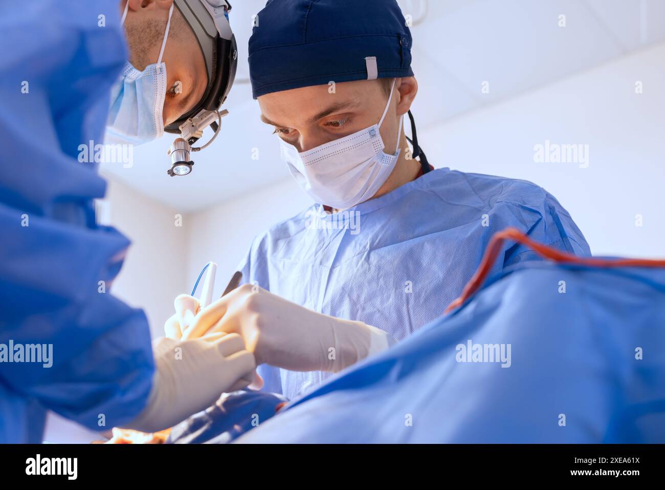 Group surgeons carrying out operation hi-res stock photography and ...