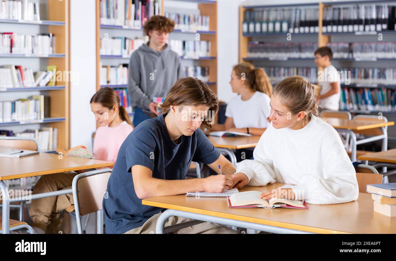 Boy and girl reading a book together hi-res stock photography and ...