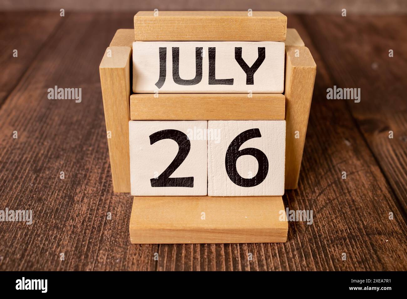 July calendar with number 26. Planner copy space on a wooden brown ...