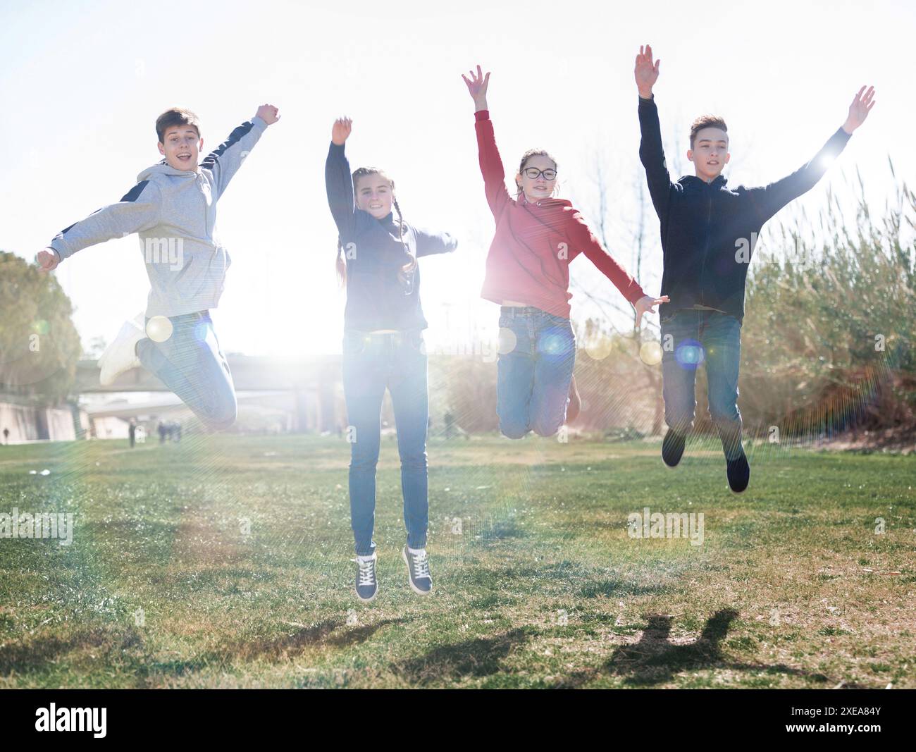 Portrait four happy friends jumping hi-res stock photography and images ...