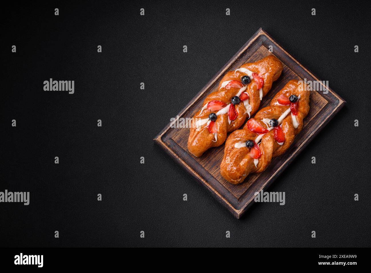 Delicious fresh crispy pastry in the form of a pigtail with ...