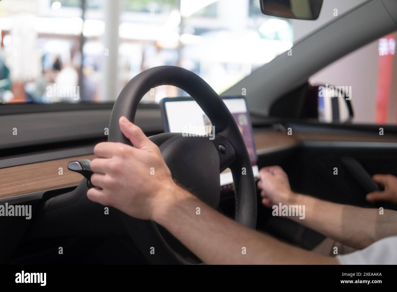 Behind steering wheel car, male hands on Driver's column, modern ...
