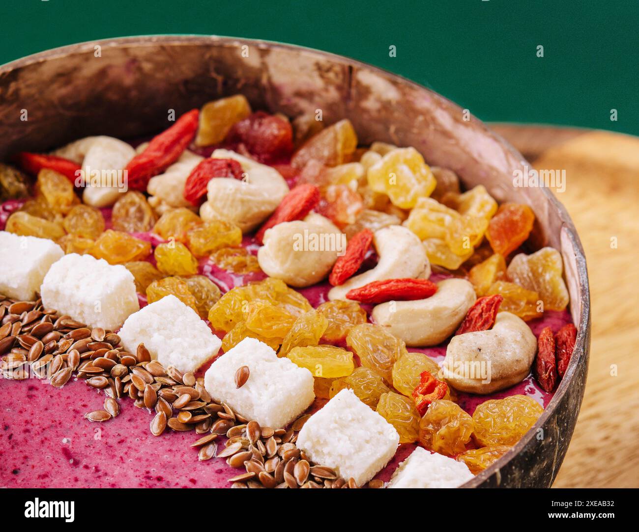 Healthy breakfast raisins and cashew nuts smoothie in coconut bowl ...