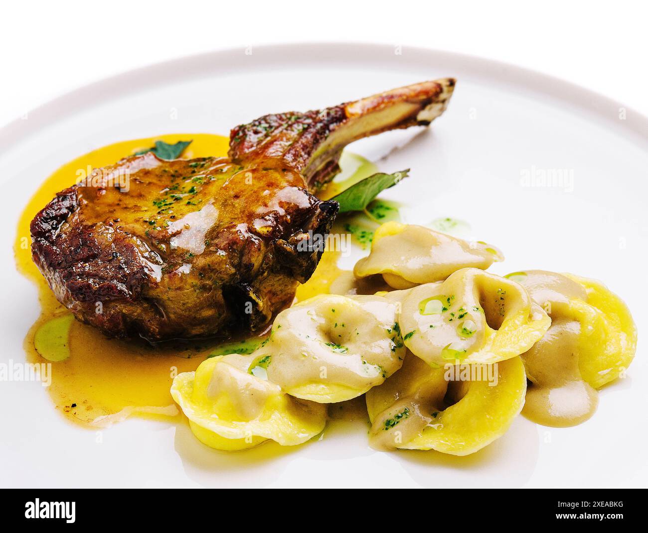 Tomahawk steak and ravioli on plate Stock Photo - Alamy