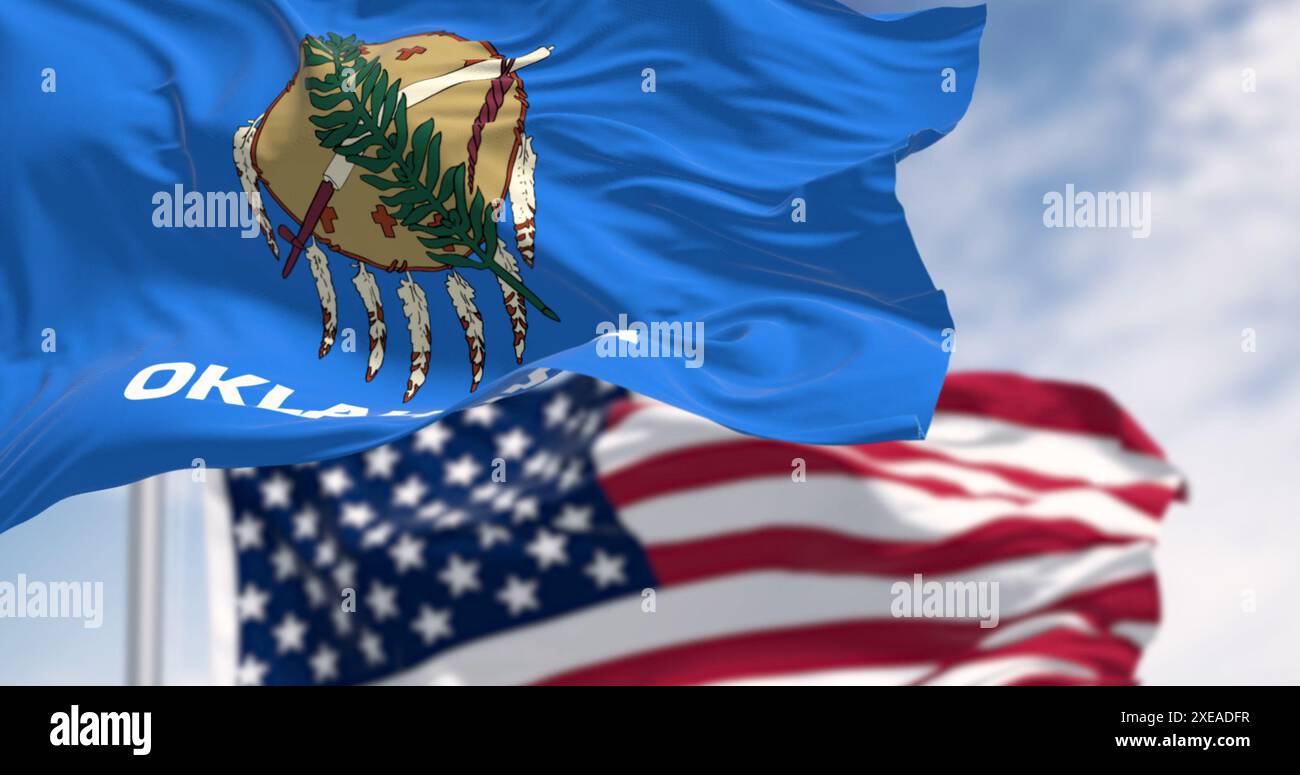 The Oklahoma state flag waving along with the national flag of the ...