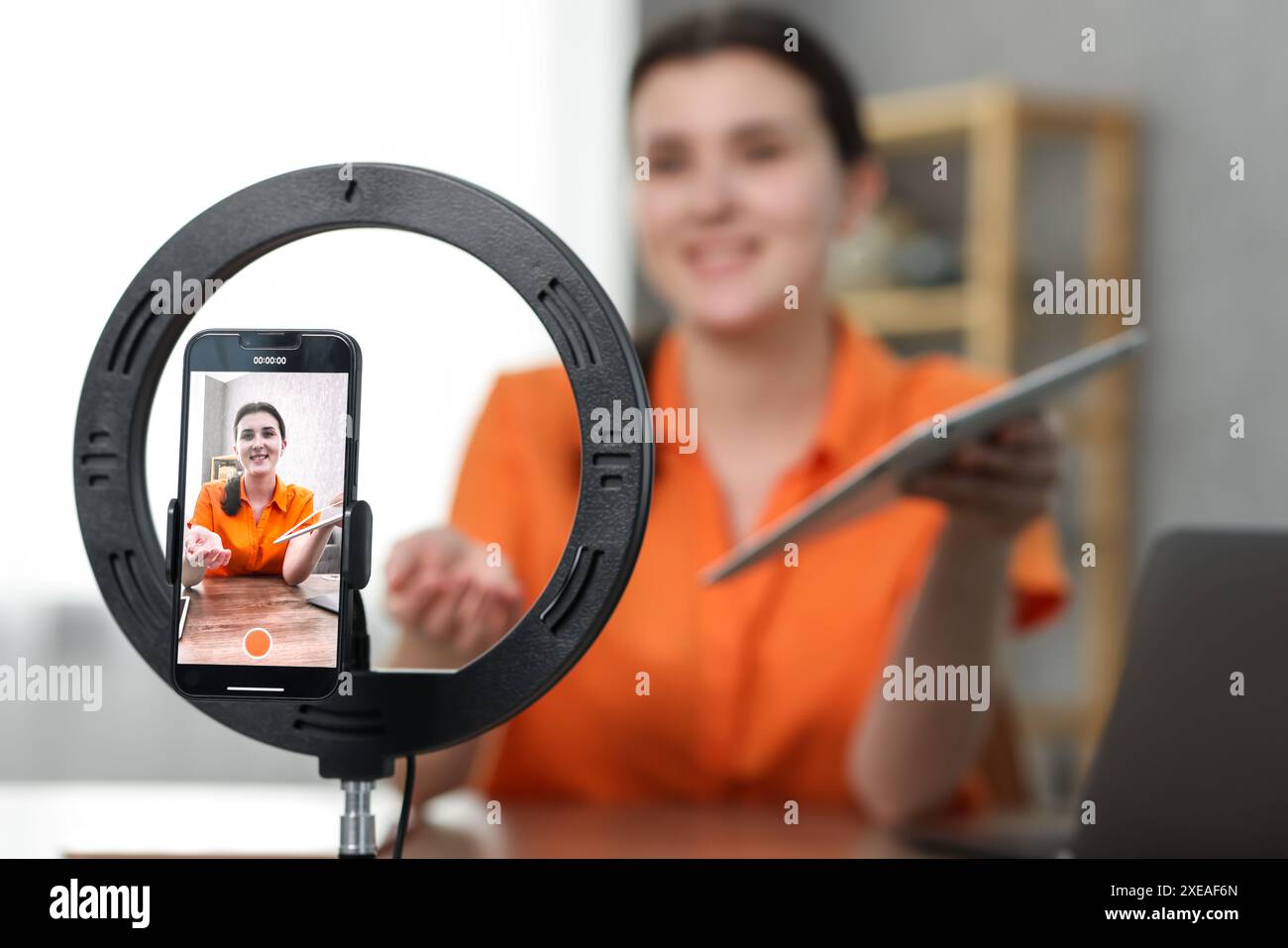 Technology blogger explaining something while recording video at home, focus on smartphone Stock ...