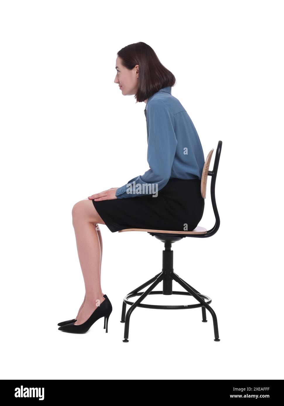 Woman with poor posture sitting on chair against white background Stock ...