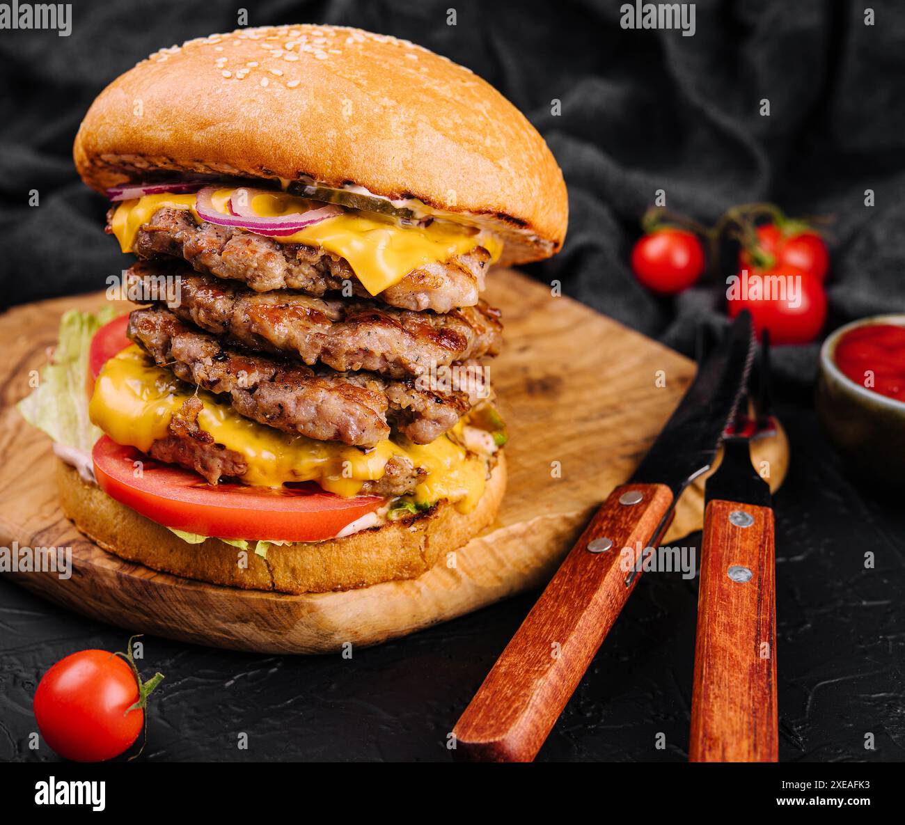 Giant hamburger fast food cutlet on wooden board Stock Photo - Alamy