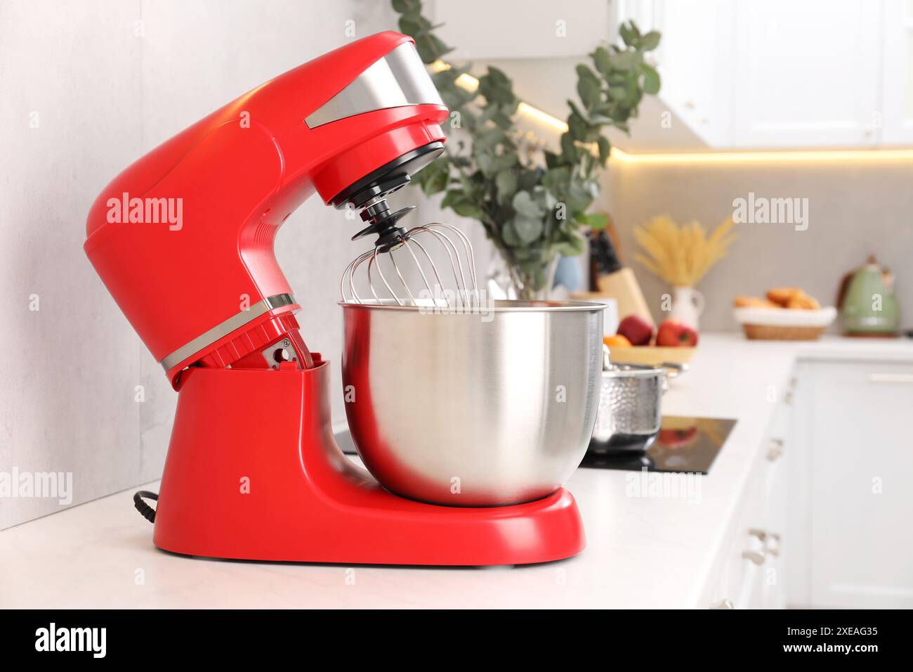 Modern red stand mixer on white countertop in kitchen Stock Photo - Alamy