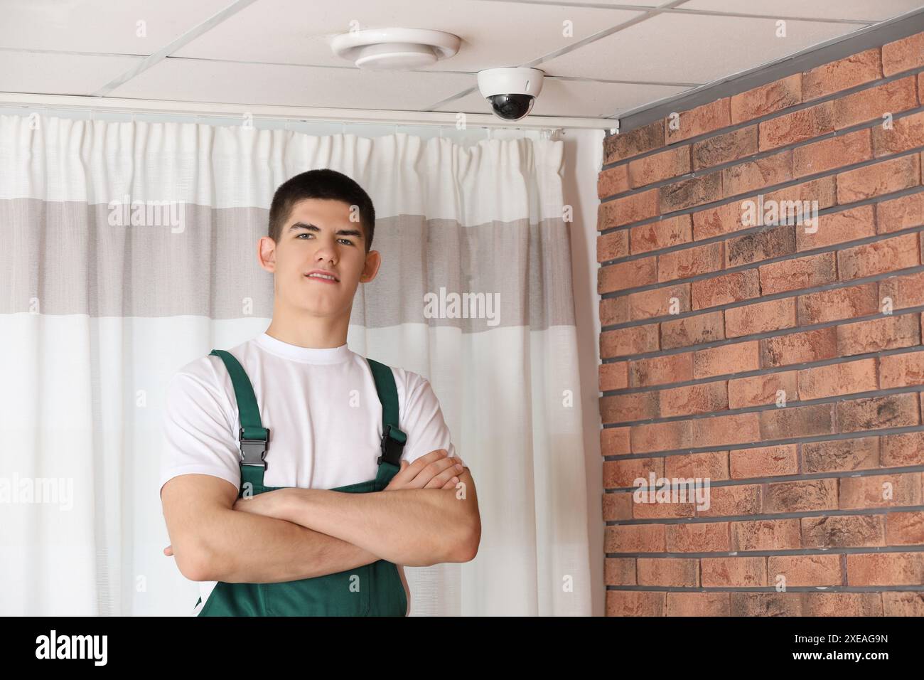 Installing CCTV camera. Portrait of technician indoors Stock Photo - Alamy