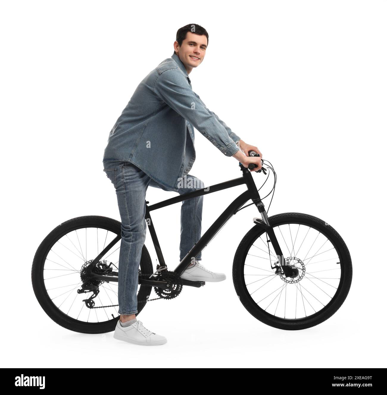 Smiling man riding bicycle on white background Stock Photo - Alamy
