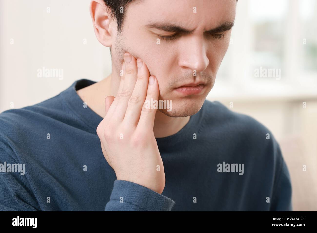 Sad man suffering from toothache at home Stock Photo - Alamy