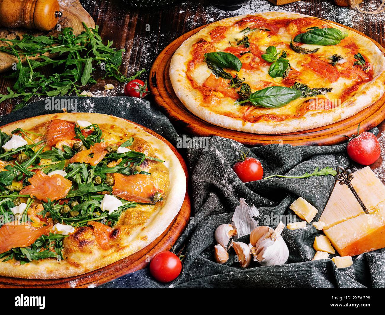 Two Different Pizzas on wooden table Stock Photo - Alamy