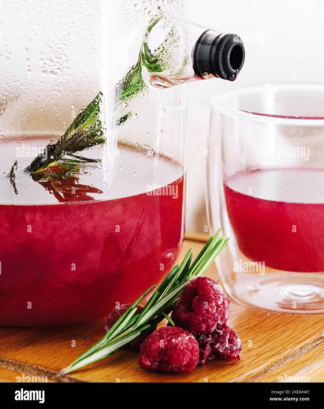 Fruit raspberry tea in glass teapot and cup Stock Photo - Alamy