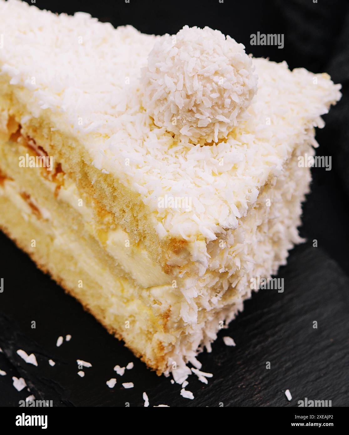 Coconut layered, raffaello cake on black tray Stock Photo - Alamy