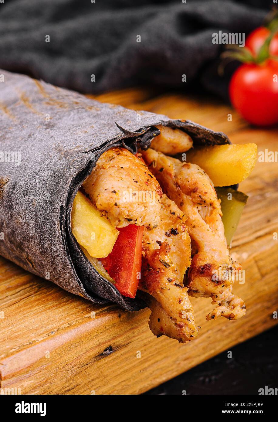Black lavash with chicken on black board Stock Photo - Alamy