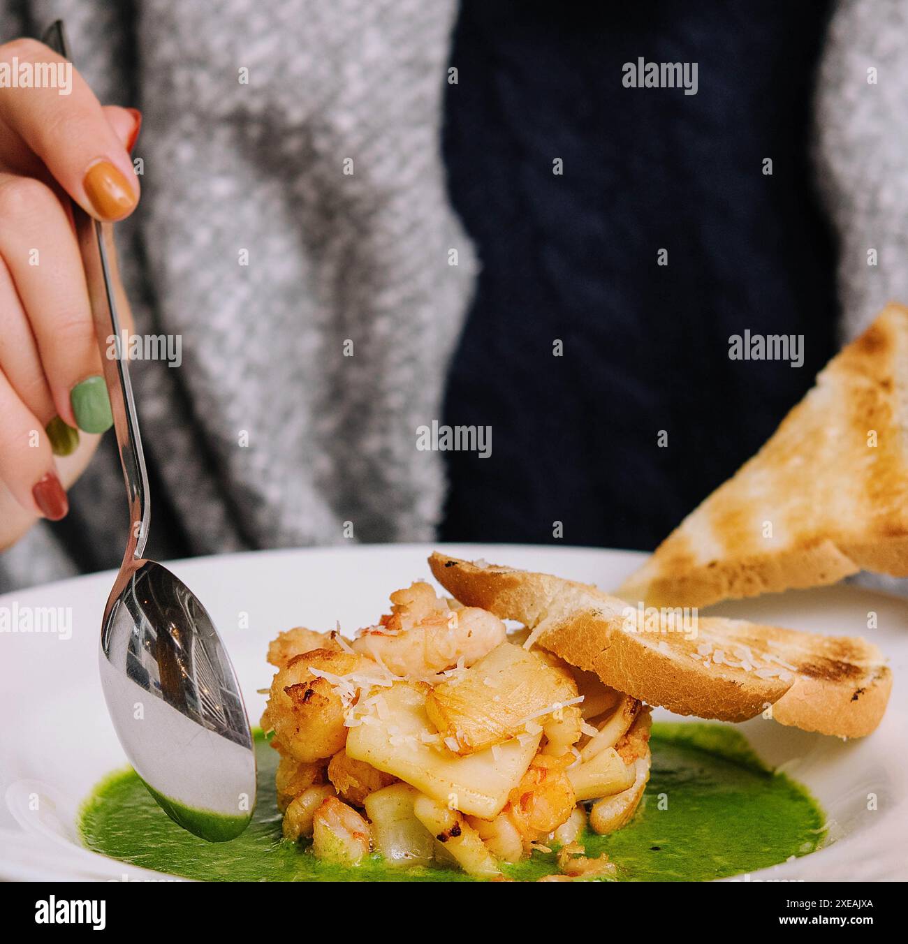 Woman eating seafood soup hi-res stock photography and images - Alamy