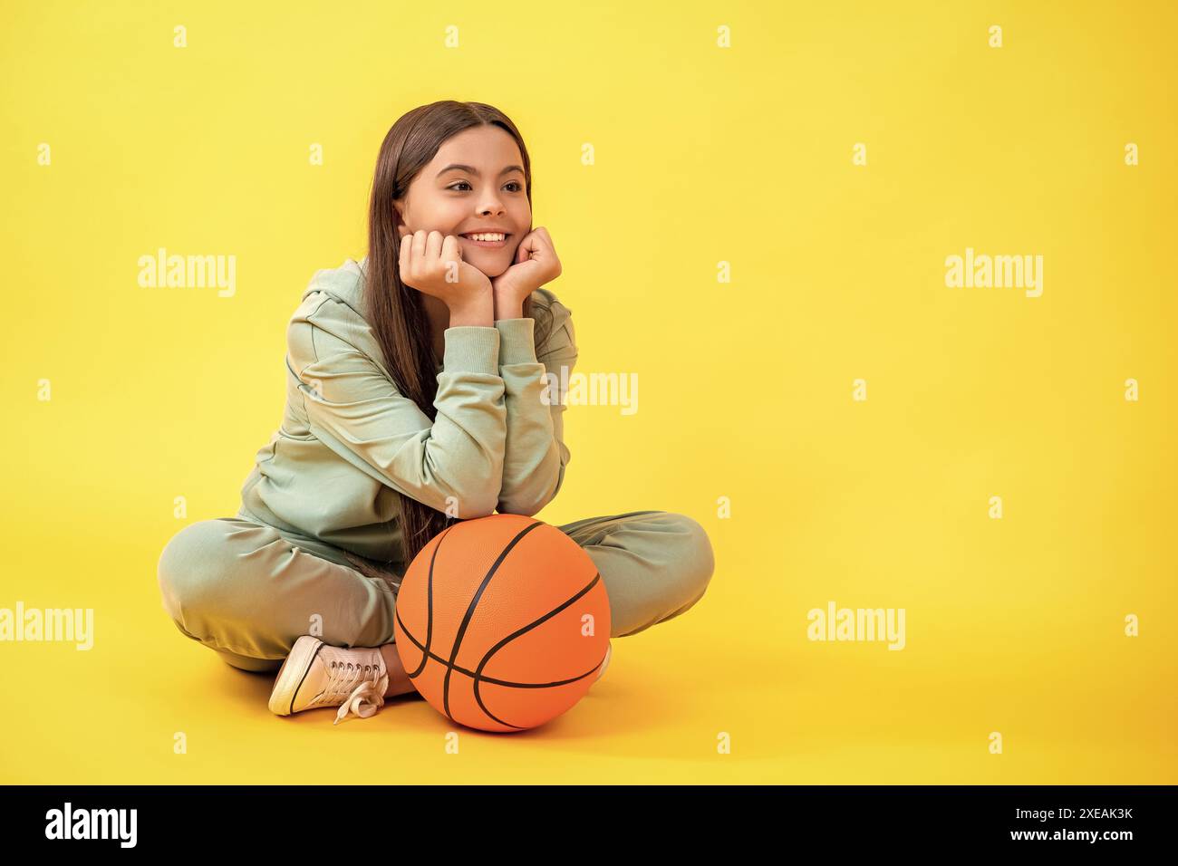 Skilled teen girl playing the basketball. Competitive teen girl playing ...