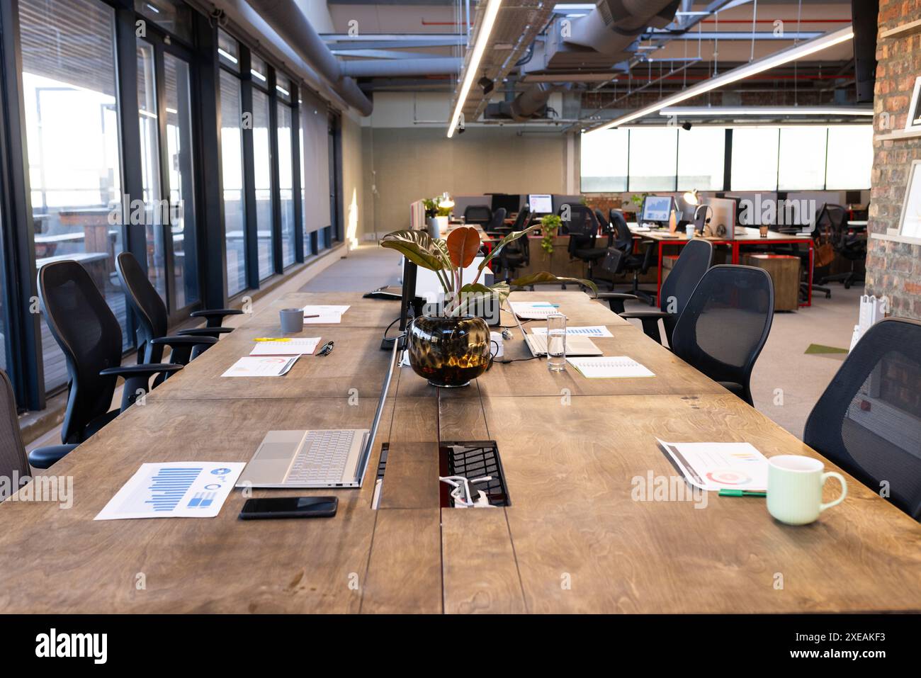 Modern office with laptops and documents on large wooden table, ready ...