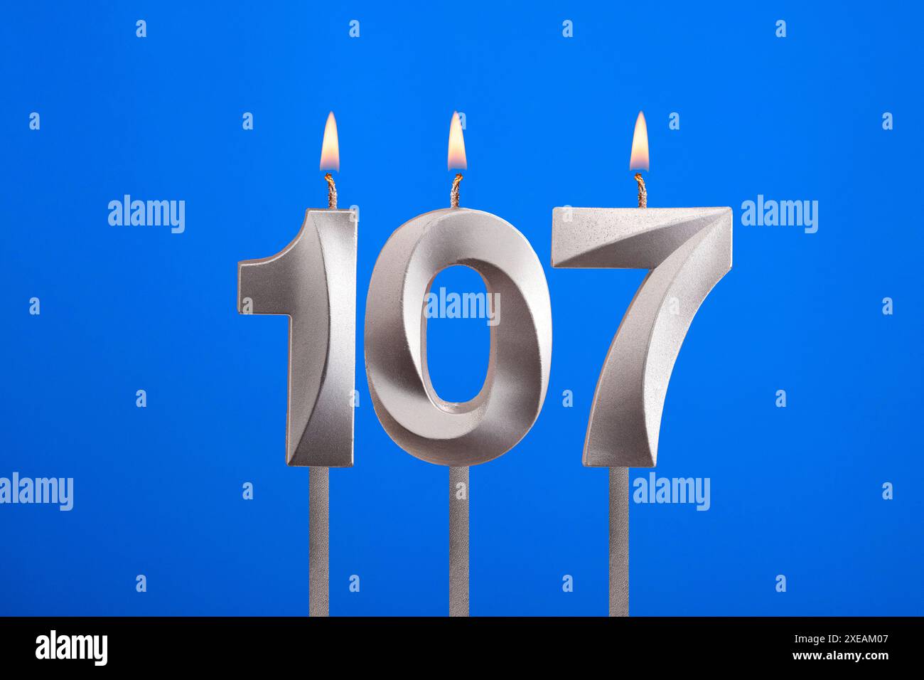 Birthday candle number 107 - Celebration card on blue background Stock ...