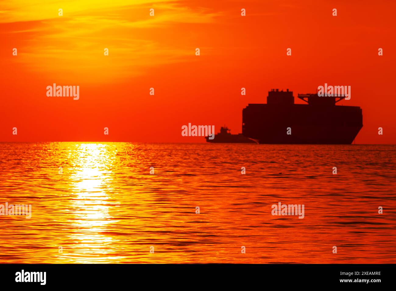 Cargo ship sailing sunset hi-res stock photography and images - Alamy