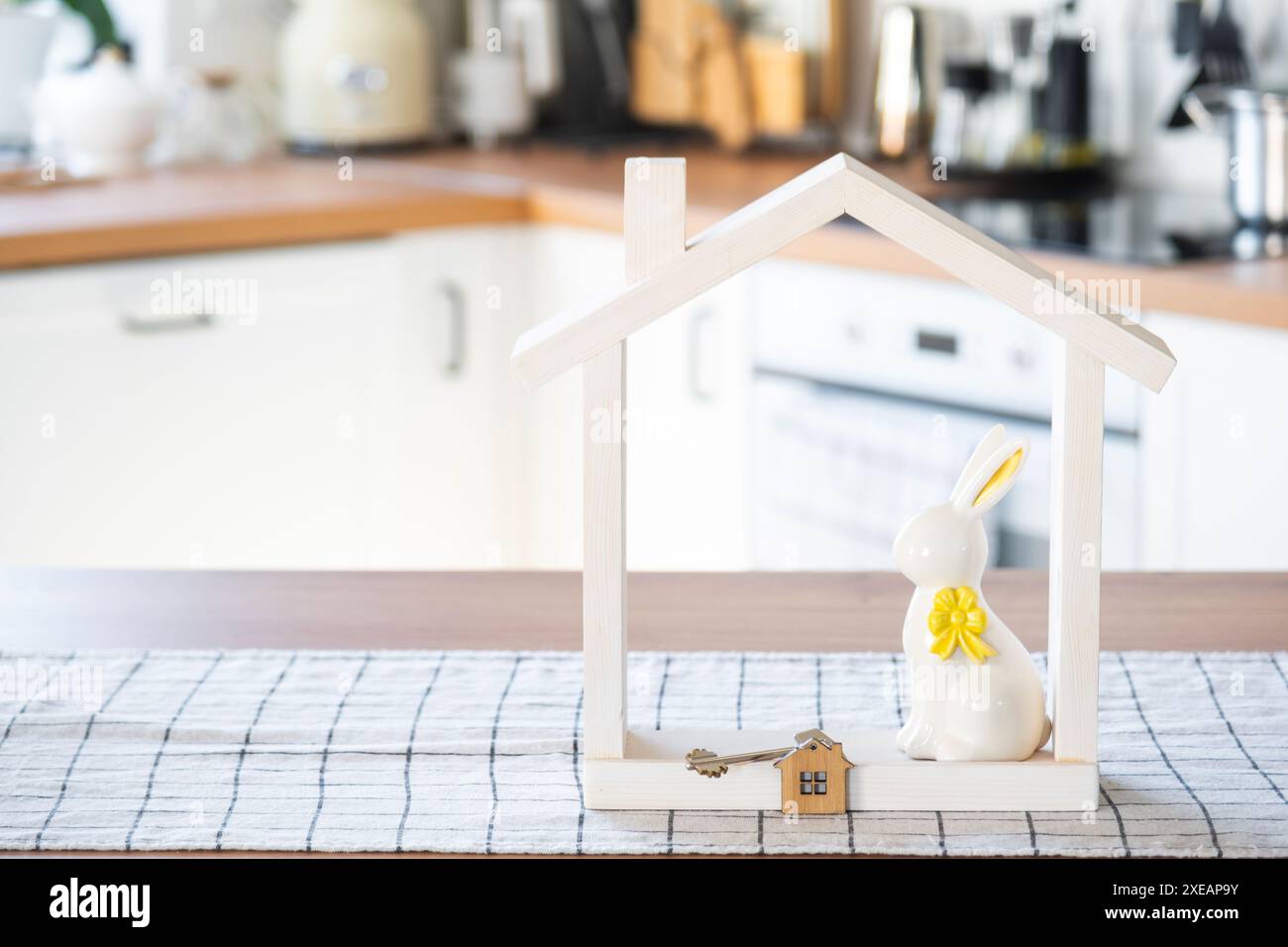 Key and tiny house of cozy home with Easter decor with rabbit and eggs ...