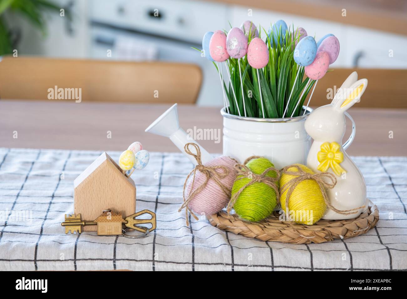 Key and tiny house of cozy home with Easter decor with rabbit and eggs ...
