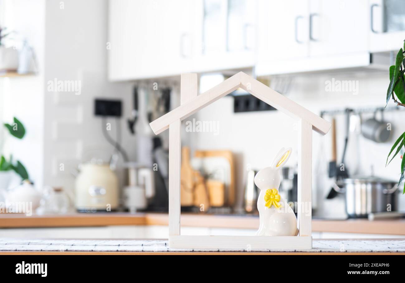 Tiny house of cozy home with Easter decor with rabbit and eggs on table ...