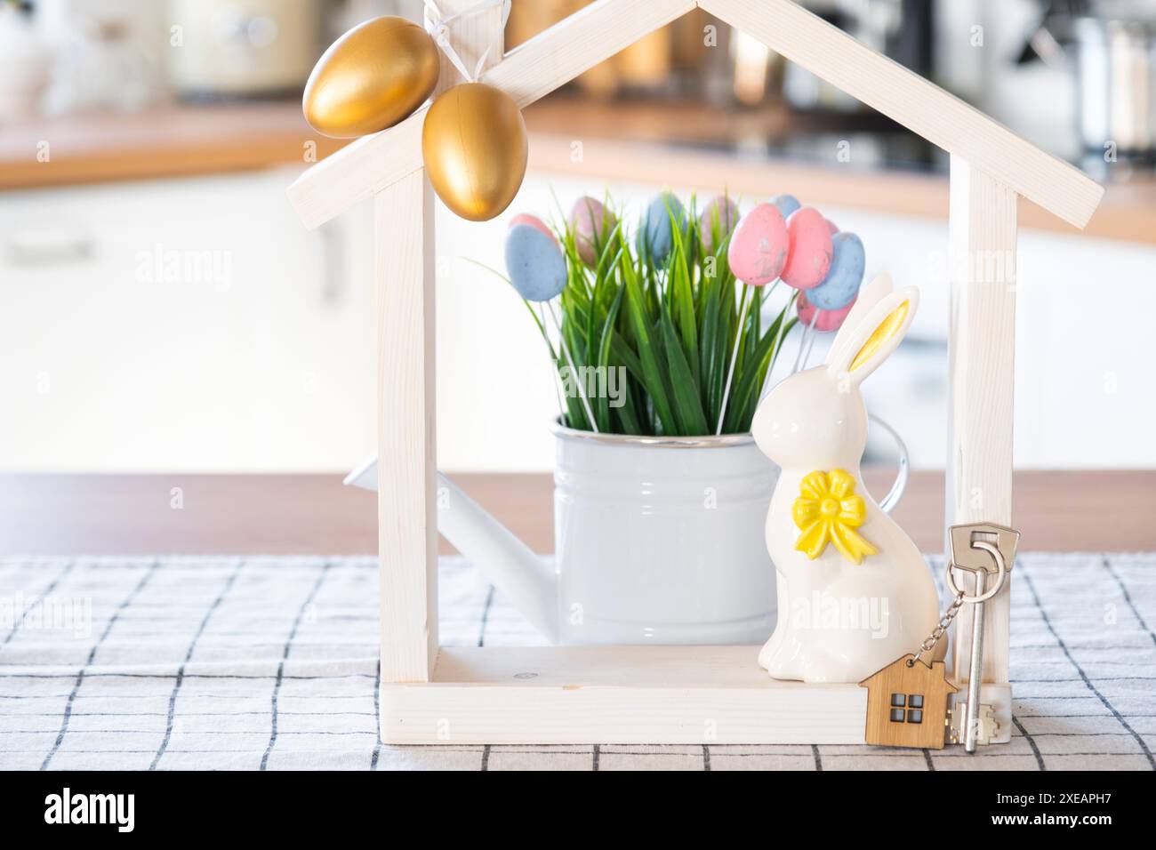 Key and tiny house of cozy home with Easter decor with rabbit and eggs ...
