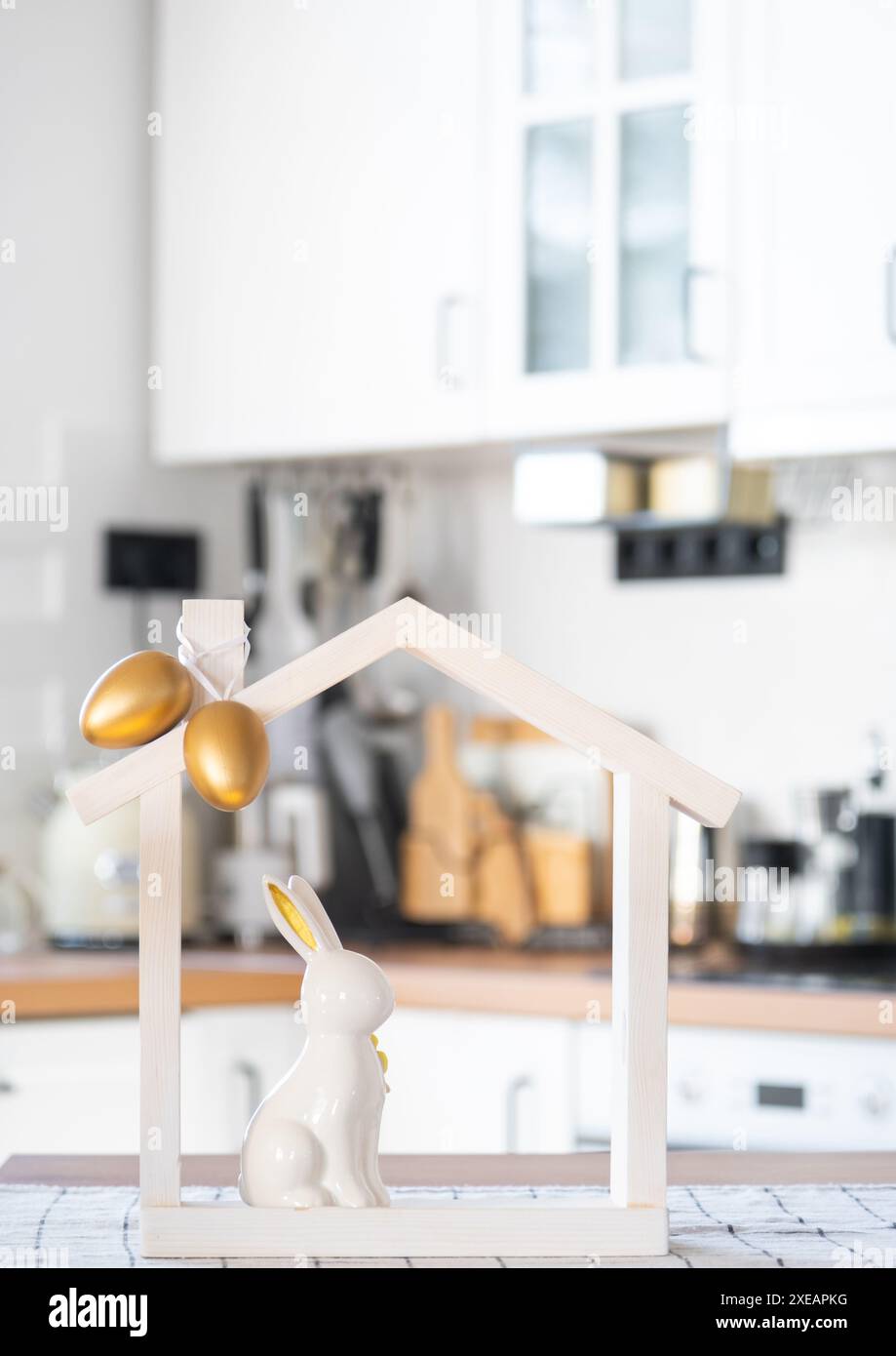 Tiny house of cozy home with Easter decor with rabbit and eggs on table ...