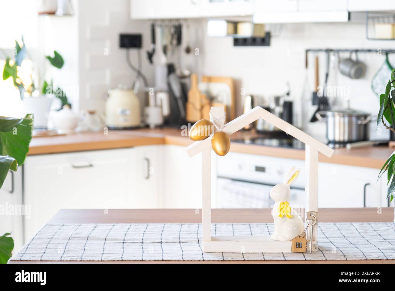 Key and tiny house of cozy home with Easter decor with rabbit and eggs ...